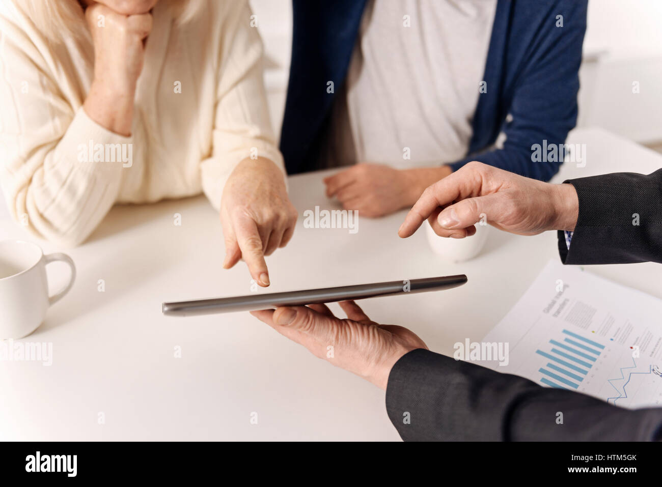 Helpful real estate agent working with aging couple of clients Stock ...