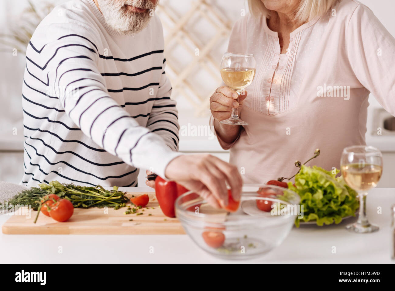 Skilled aged partners cooking together in the kitchen Stock Photo - Alamy