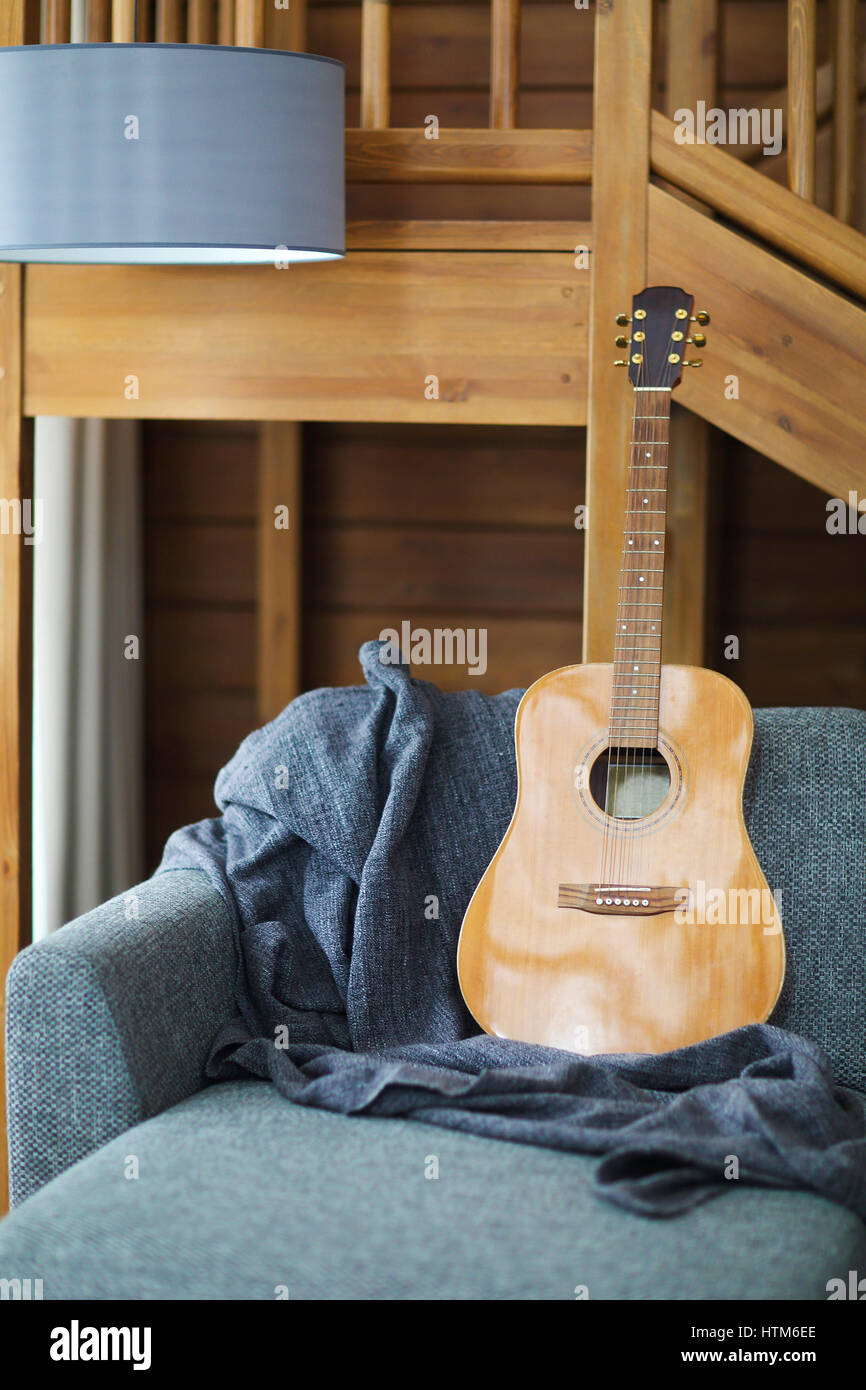 Cozy living room with guitar on the sofa in the wooden house Stock ...