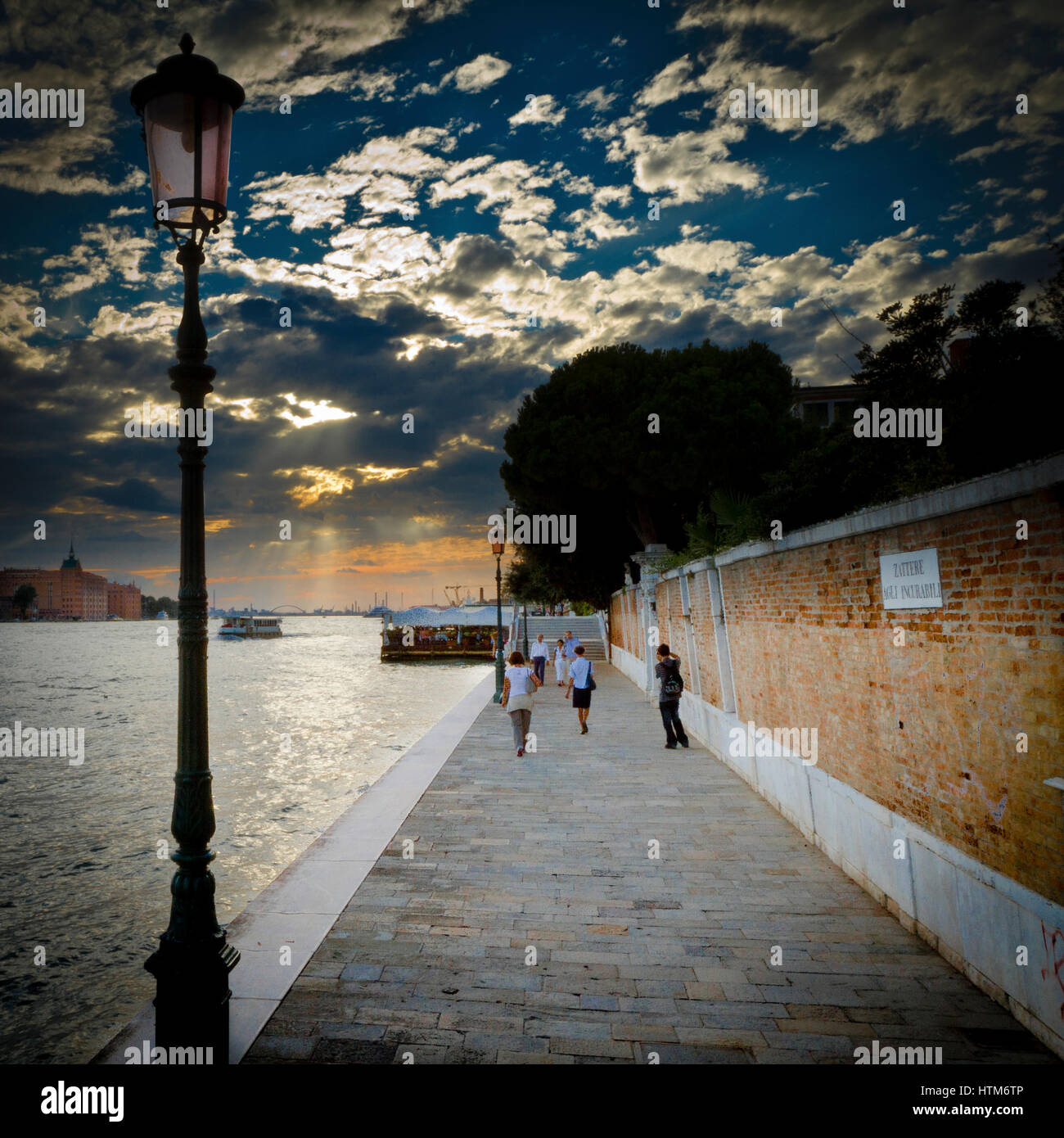 People walking along the Zattere promenade alongside the Giudecca Canal ...