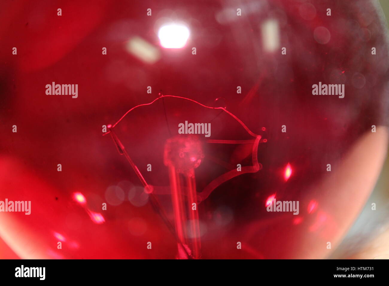 Filament inside a red bulb Stock Photo - Alamy
