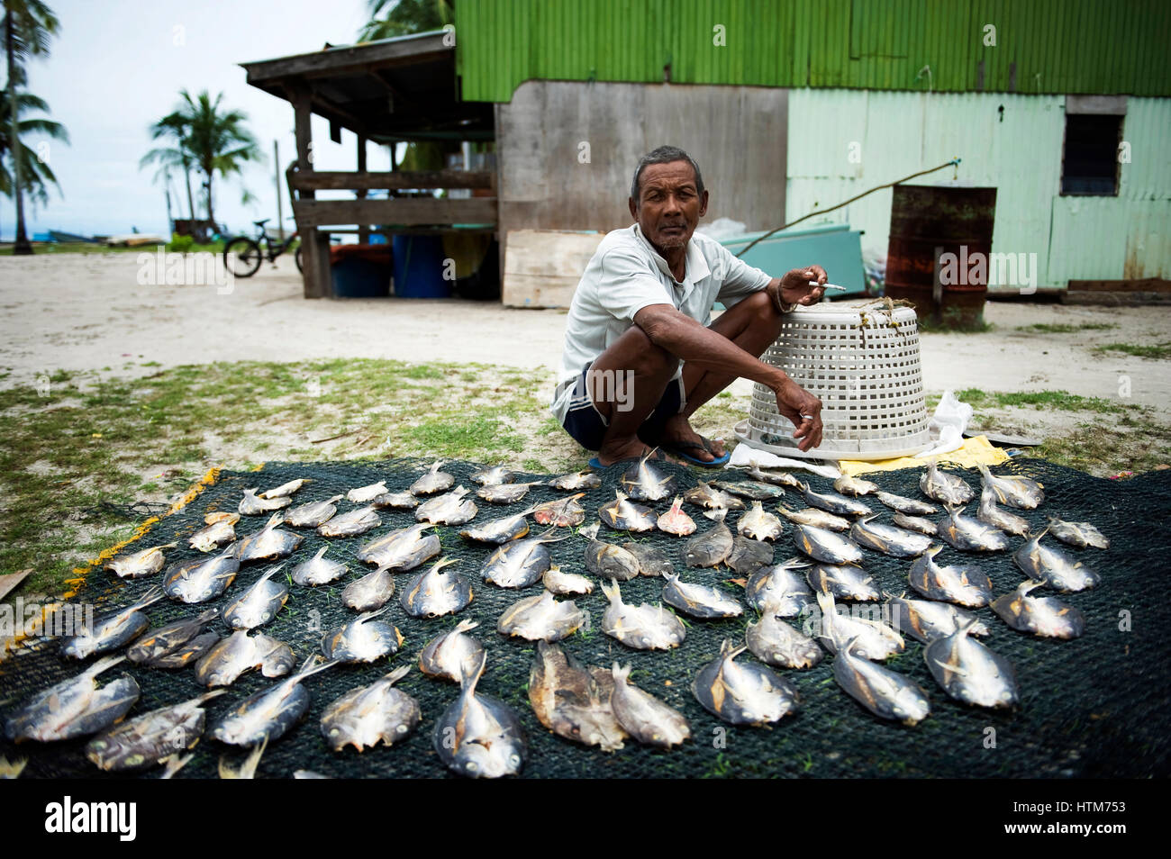 A smoking fish seller on the Mantanani Island. The Mantanani Islands is ...