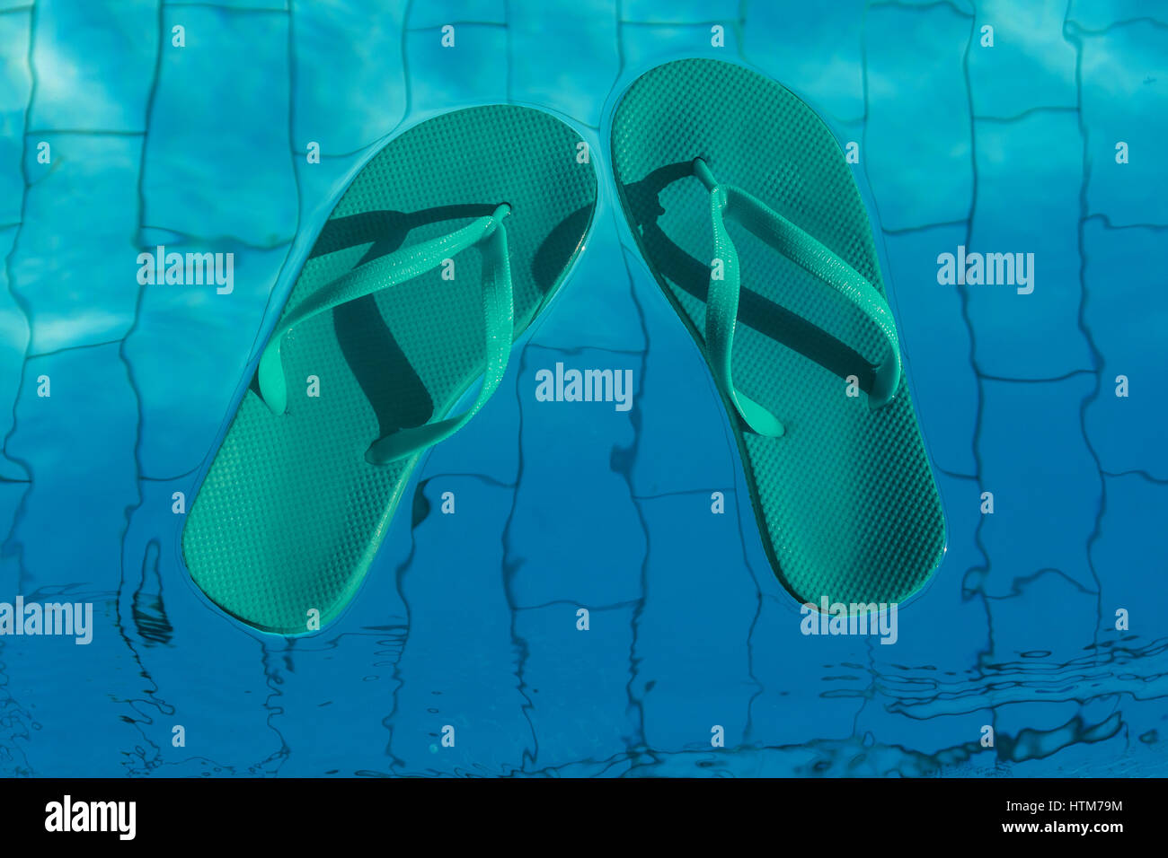blue flip-flops floating in a swimming pool, a top view Stock Photo - Alamy