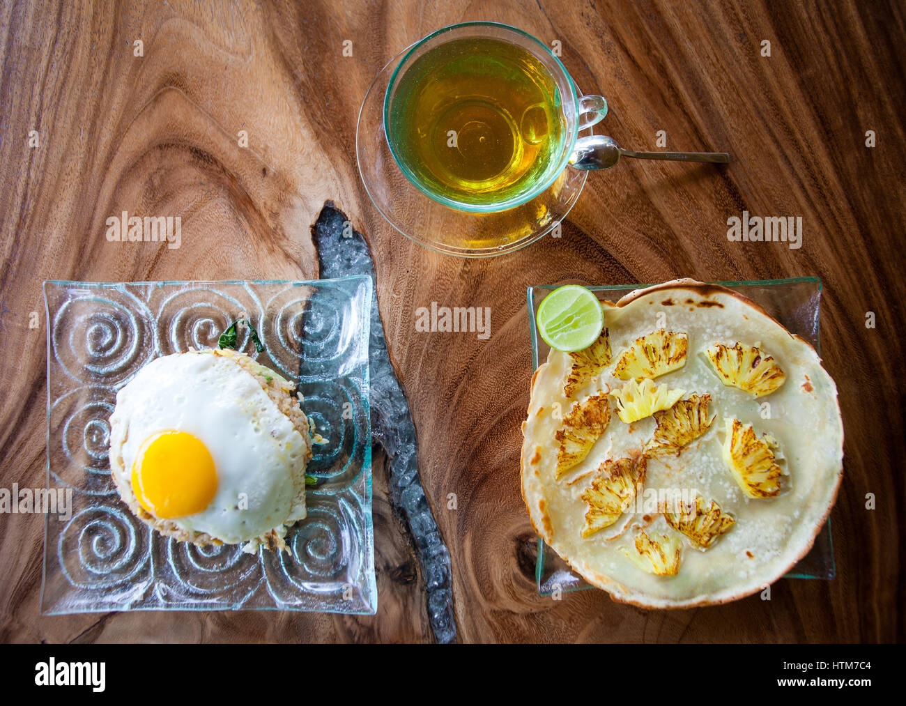 Traditional Asian Breakfast, rice with egg, pancake with pineapple and ...