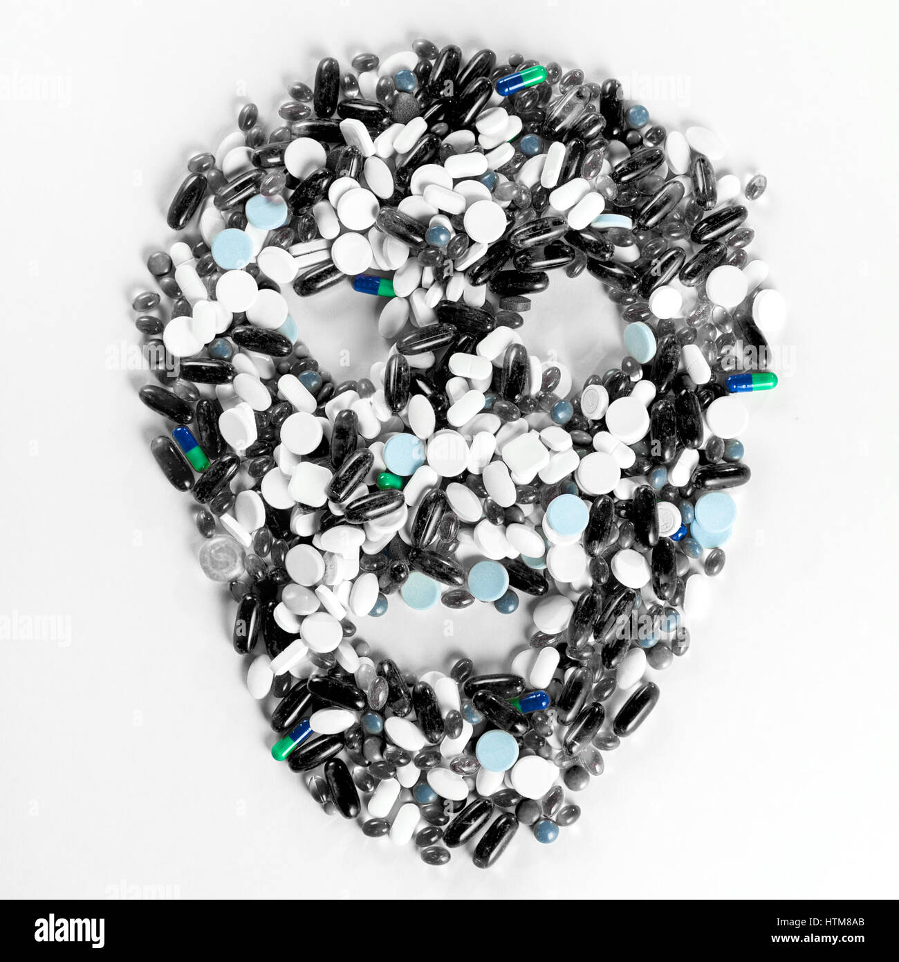 Tablets, pills and capsules, that shape a creepy skull on white ...