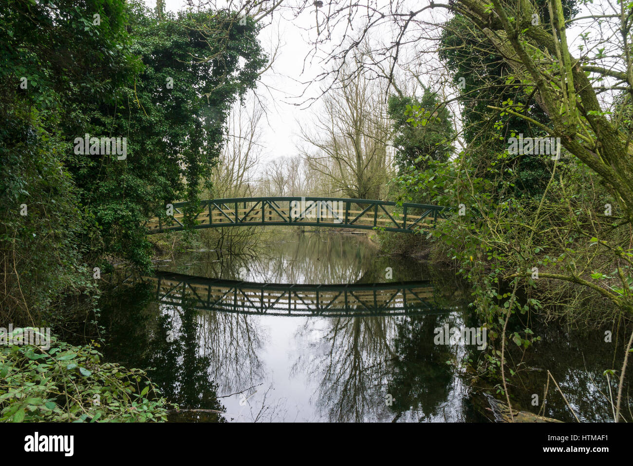 Footbridge over lake and reflection Stock Photo - Alamy