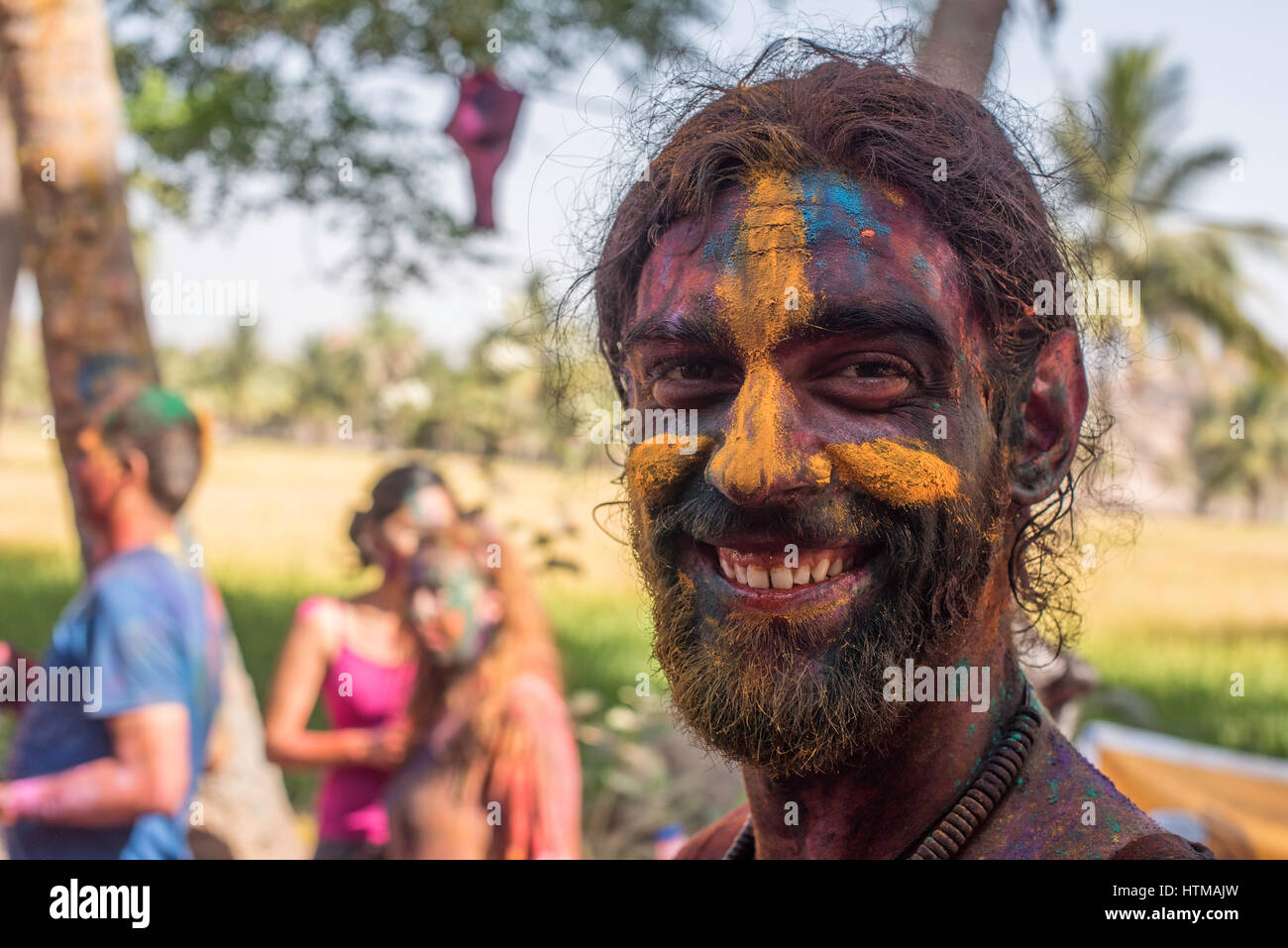 Man smiling at the camera whilst celebrating Holi in Hampi Stock Photo ...