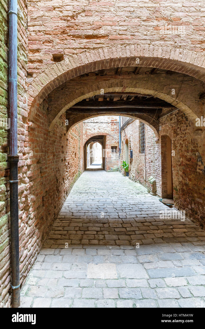 Old alley with brick walls in an old Italian village Stock Photo - Alamy