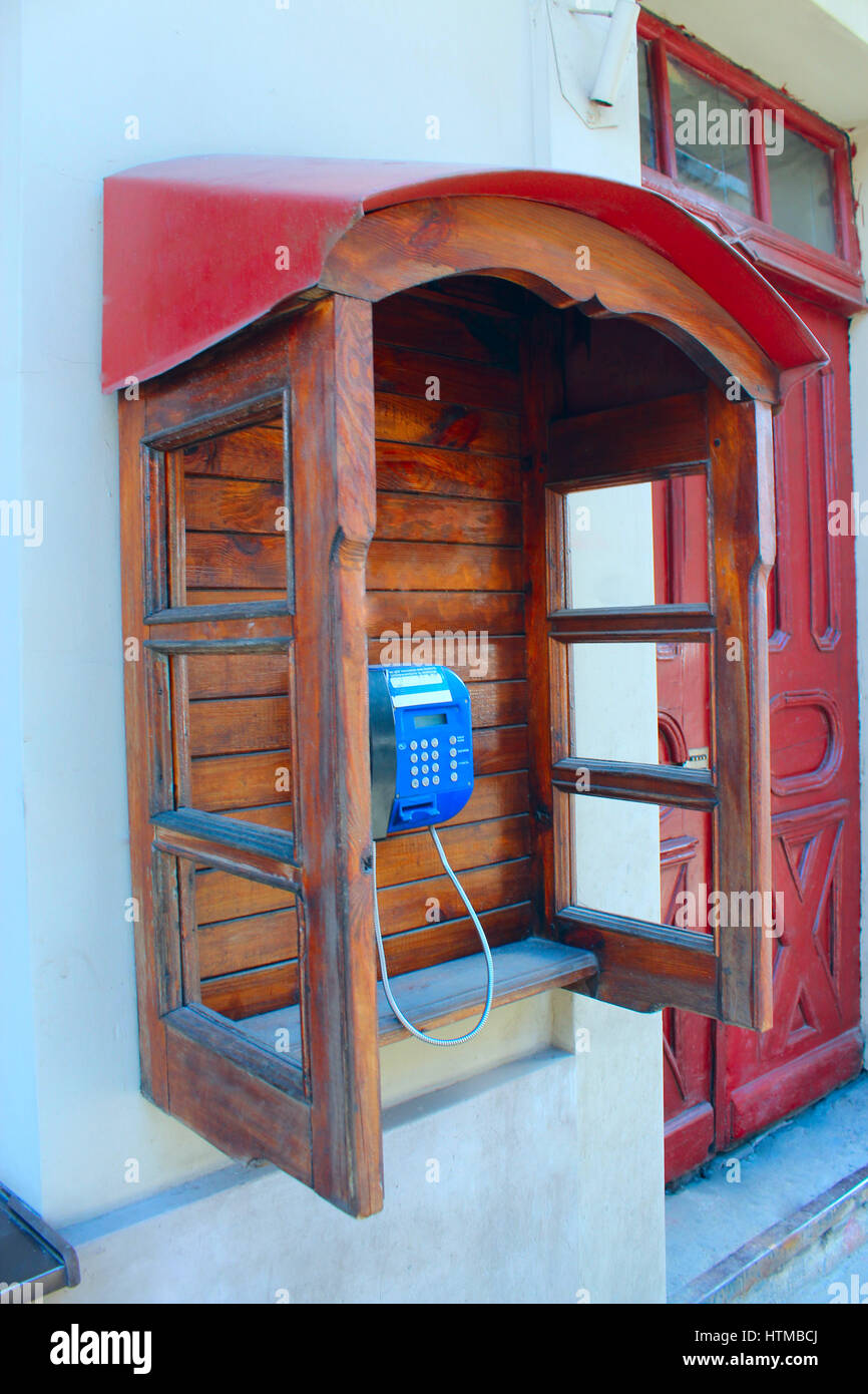 opened cabin with blue street pay phone Stock Photo - Alamy