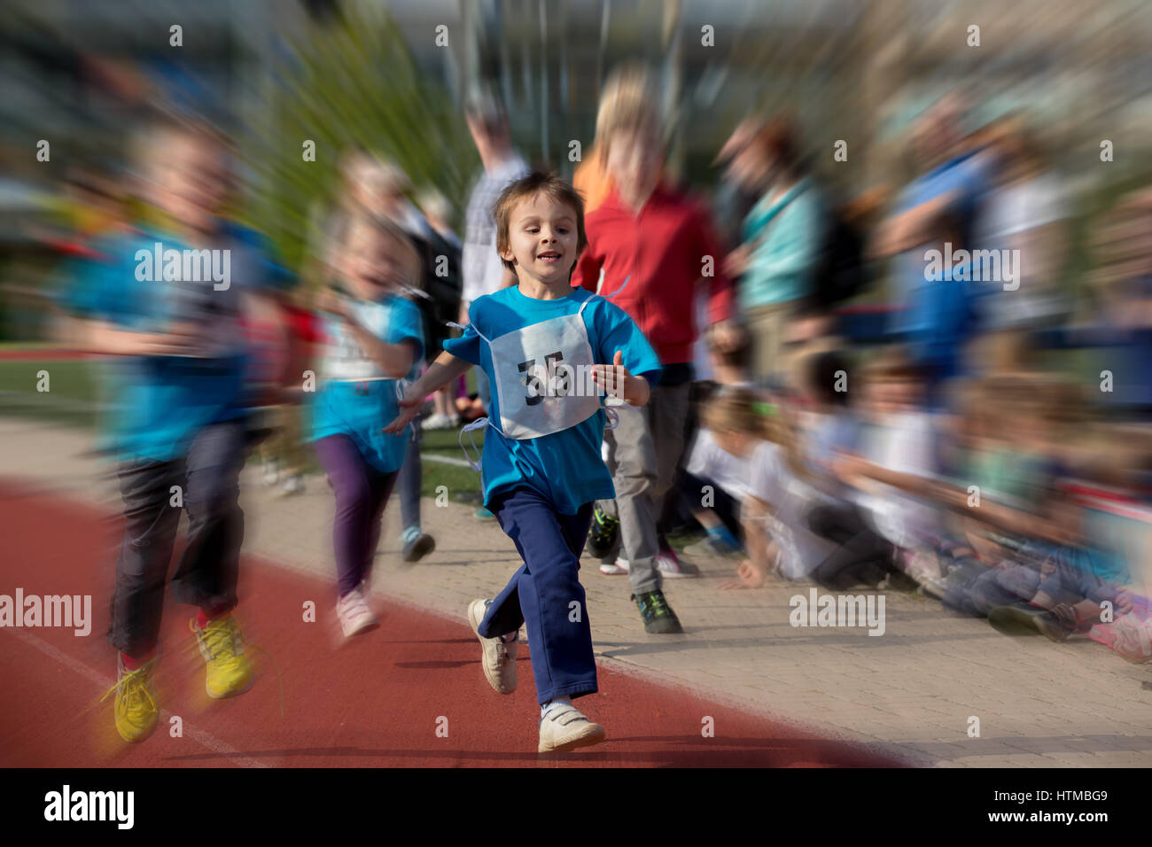Preschool children run on the marathon road in a competition Stock ...