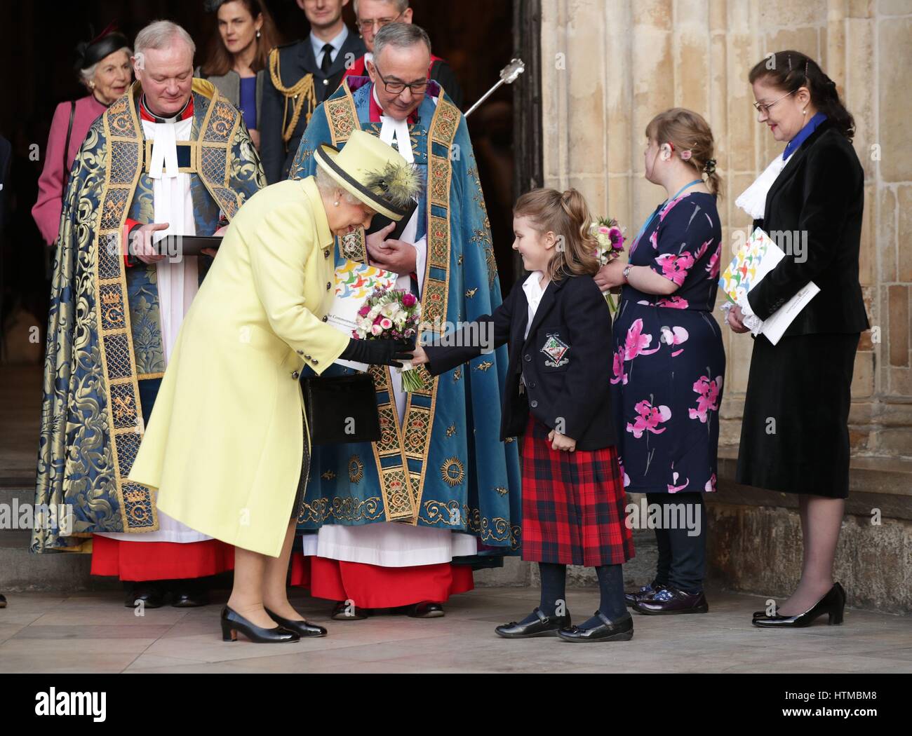 Queen Elizabeth II receives flowers following the Commonwealth Service ...