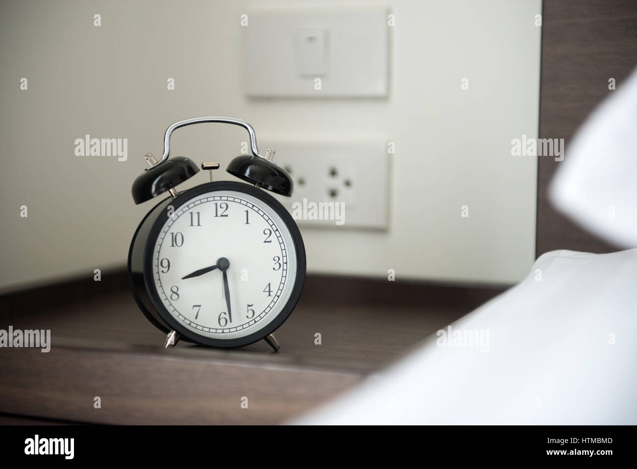 alarm clock on bed side table Stock Photo - Alamy