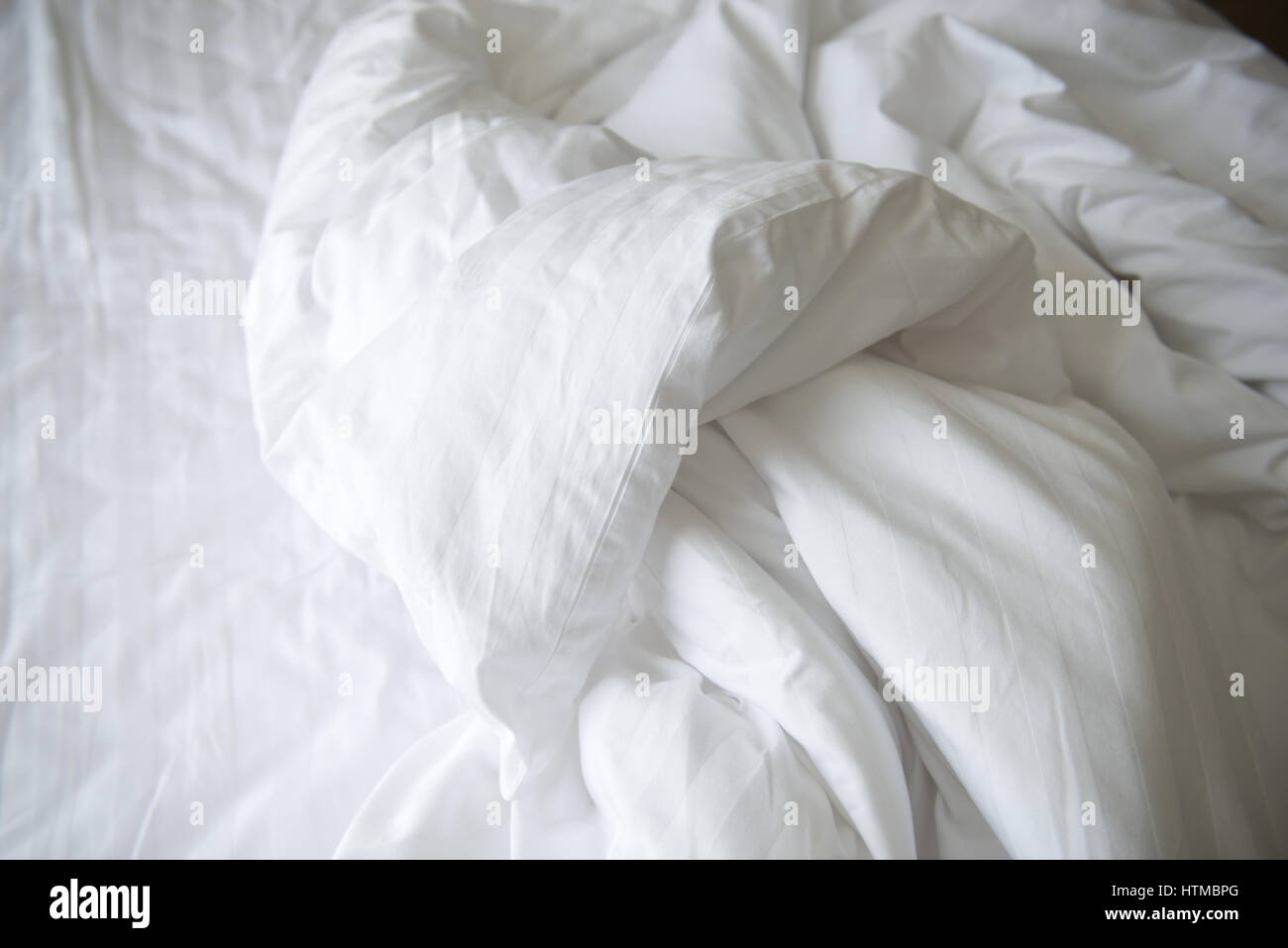 messy blanket on bedding Stock Photo - Alamy
