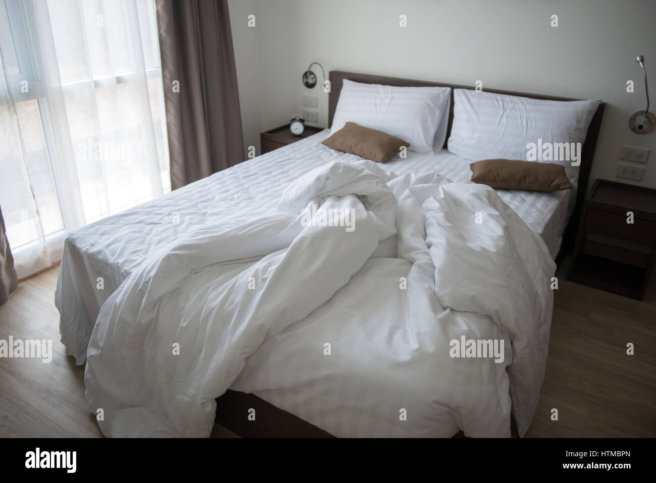 alarm clock on bed side table Stock Photo - Alamy