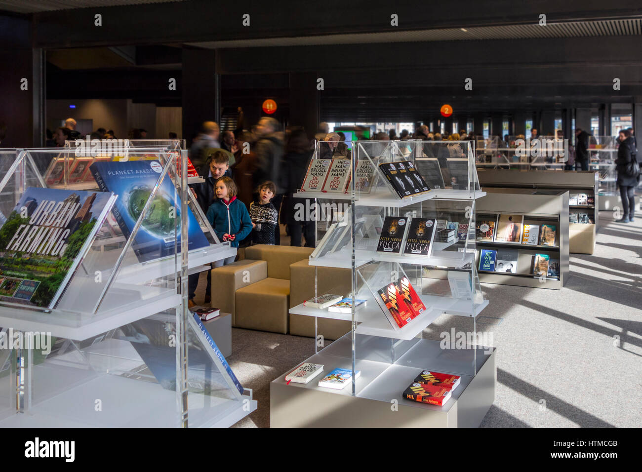 Visitors looking at books in De Krook, new public library in the city ...