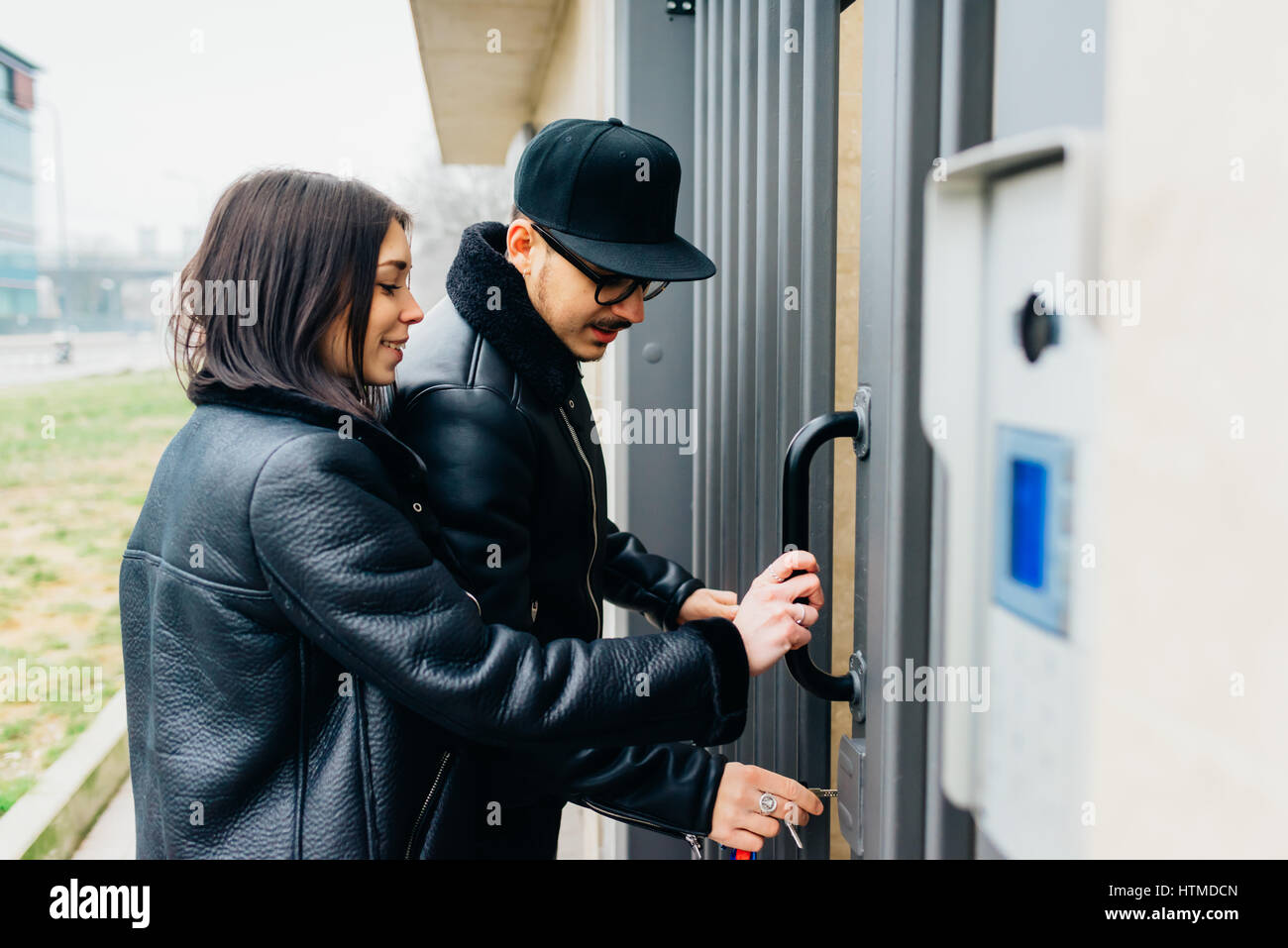 Young beautiful couple opening front door of their new house - love ...
