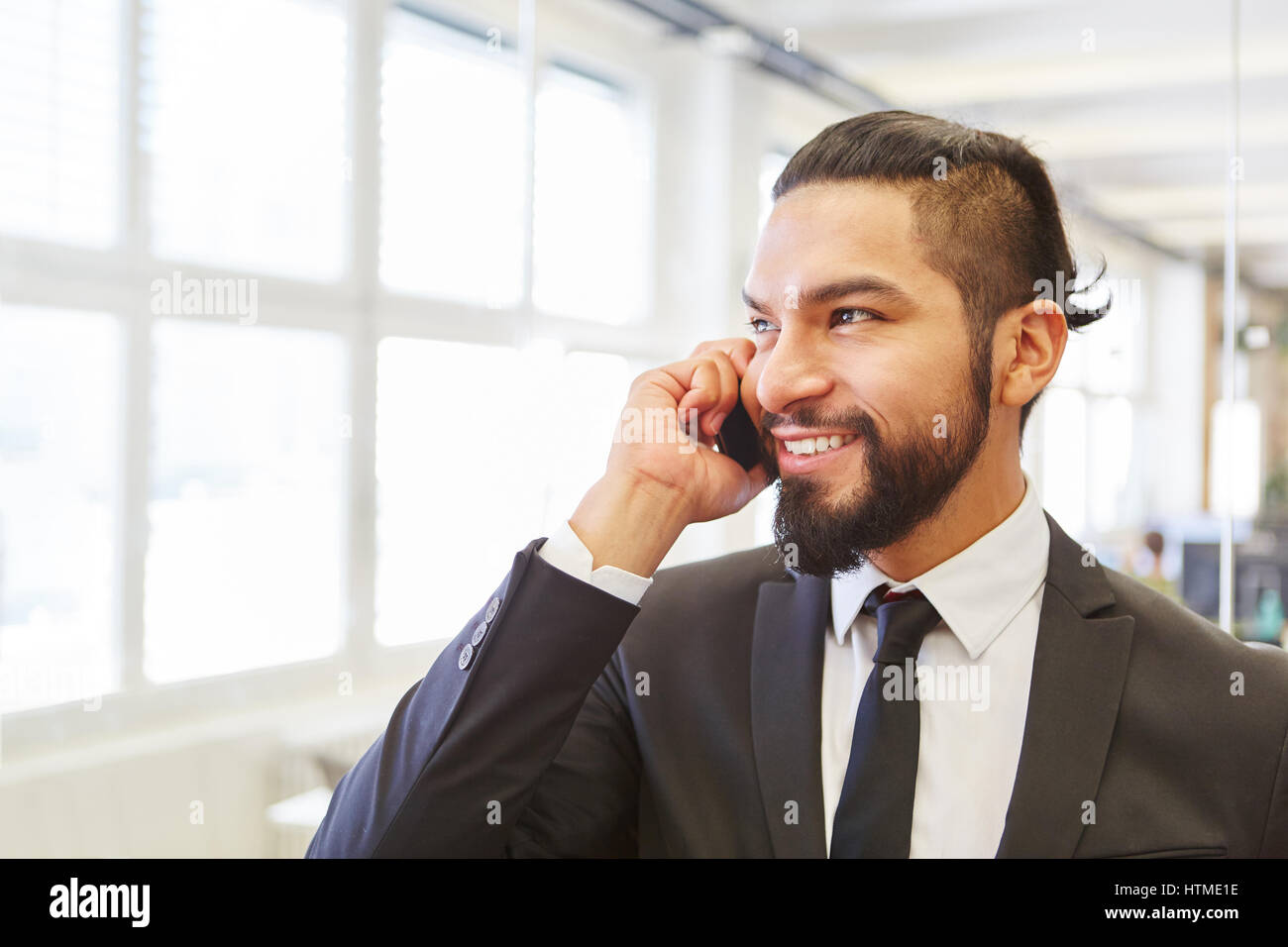 Successful businessman calling with phone and receiving successful news ...