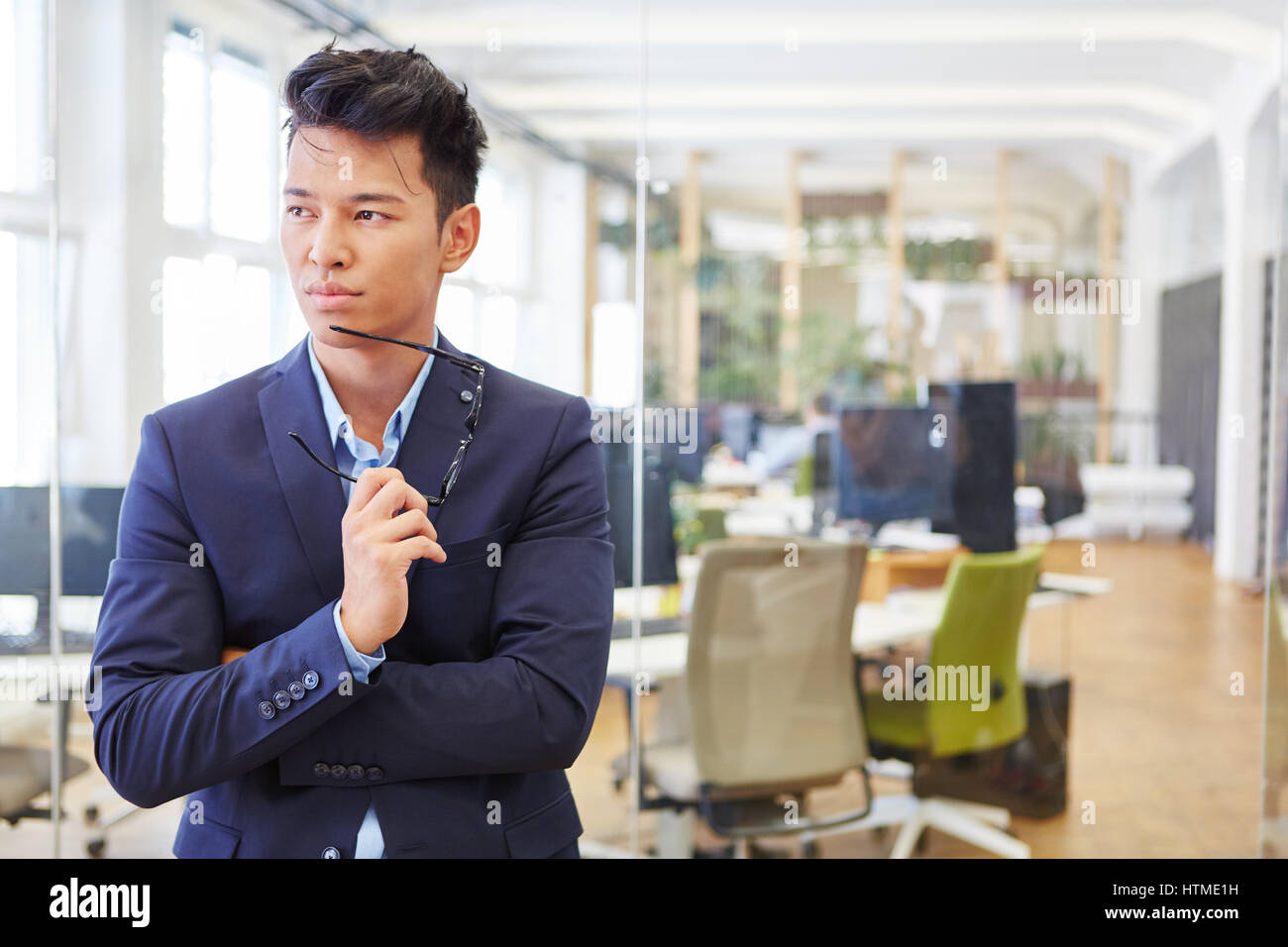 Asian man as manager with responsability thinking about decision Stock ...