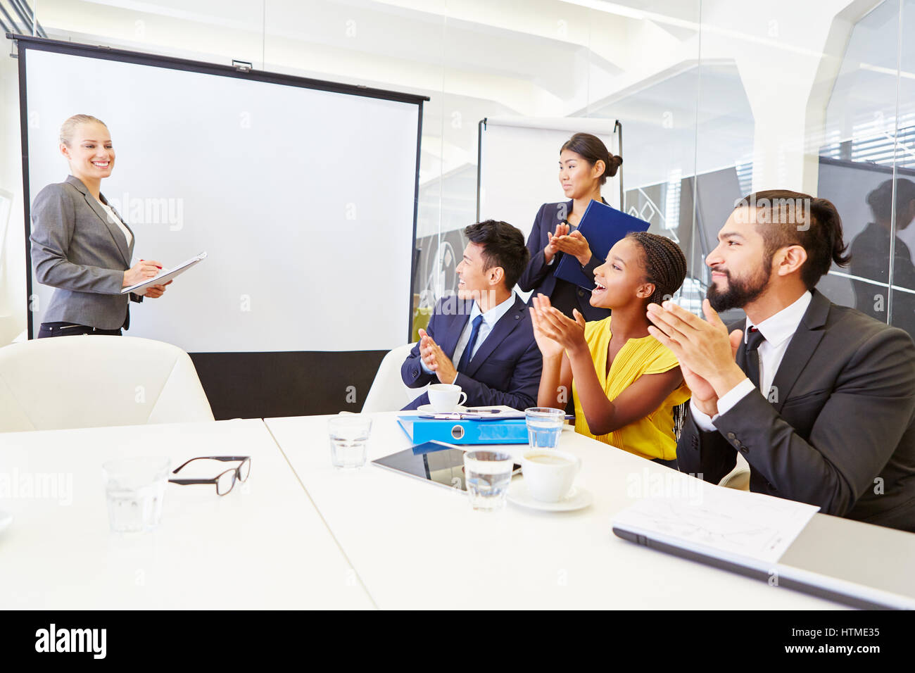 Audience in business seminar clapping after lecturer's presentation ...