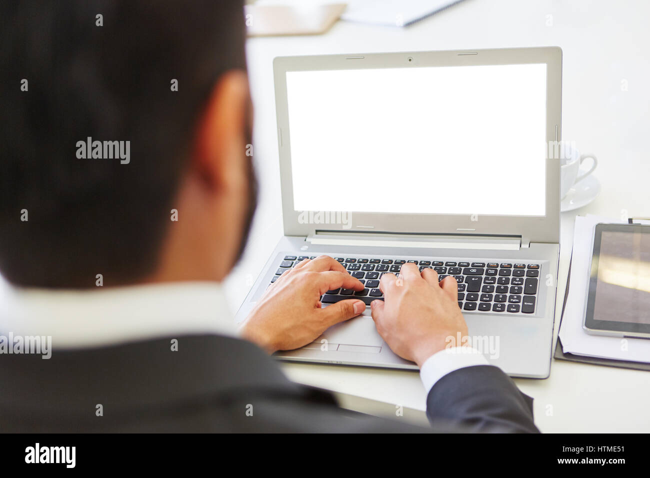 Man writes on laptop computer with white empty screen Stock Photo - Alamy