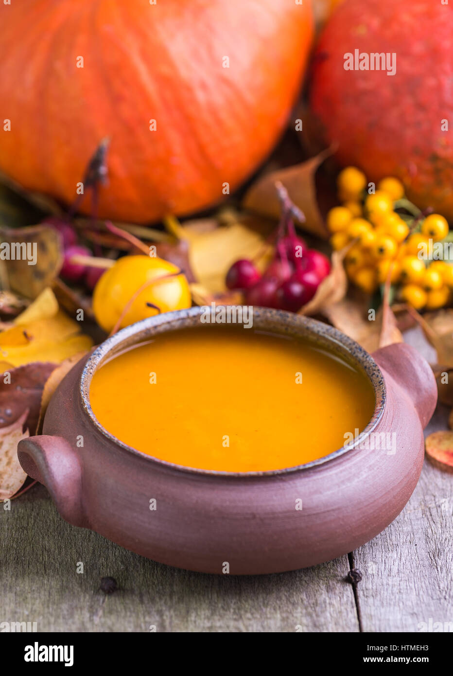 Autumn pumpkin soup in home crafted bowl on natural desk Stock Photo ...
