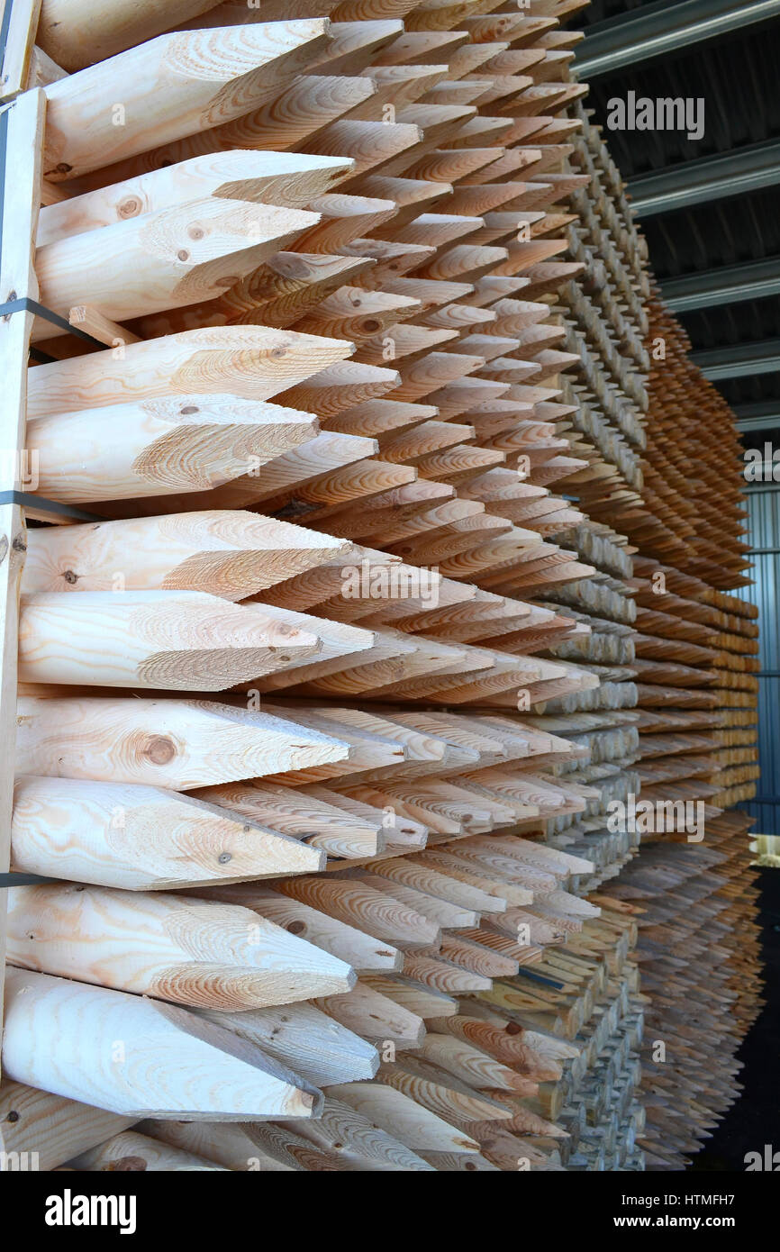 sharpened ends of stakes of wood stacked in a warehouse of finished ...