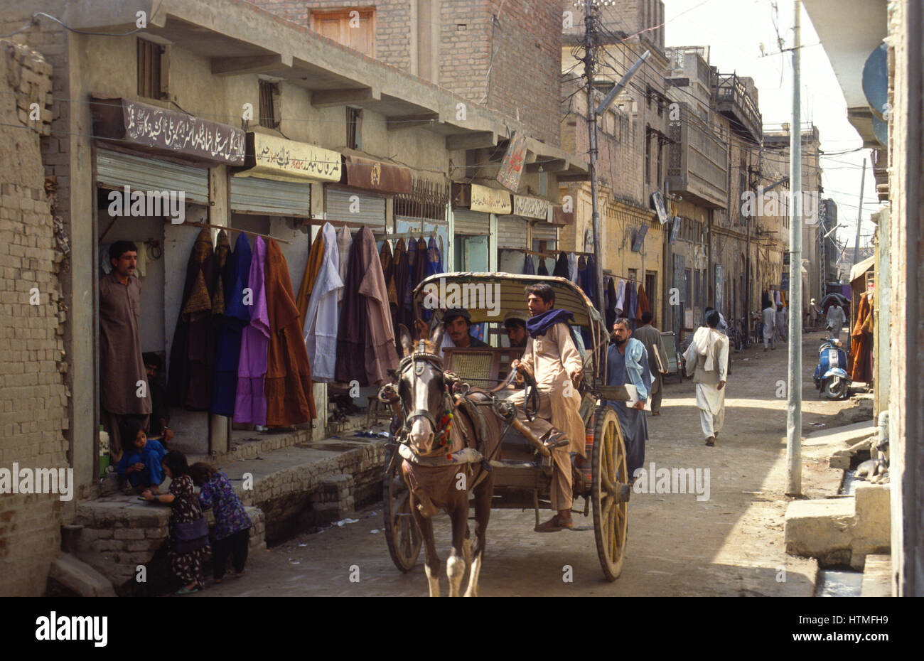 calesa or horse cart and burqa shop in Bannu, Pakistan Stock Photo - Alamy