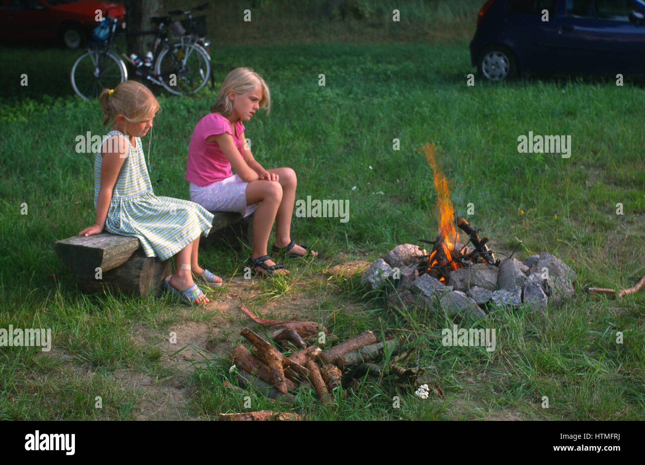 two girls enjoying a campfire Stock Photo - Alamy