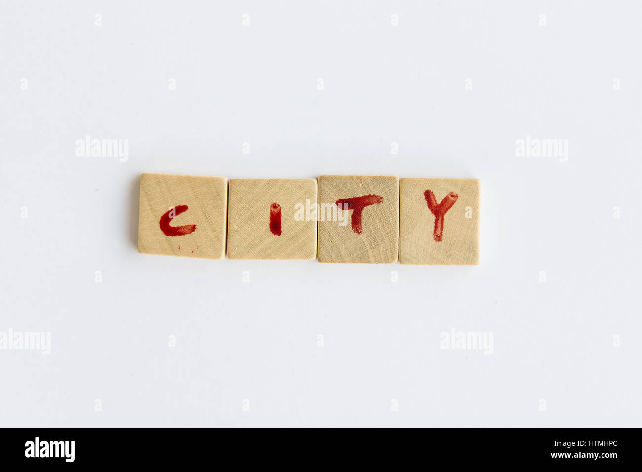the word City formed with letters written on squares of wood dowels ...