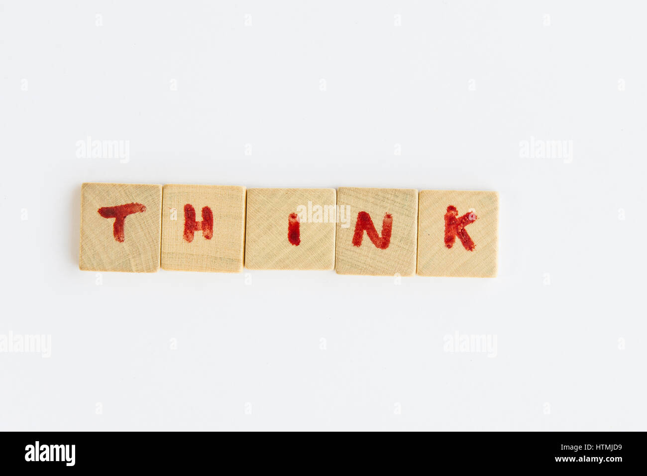 the word "Think" formed with letters written on squares of wood dowels ...