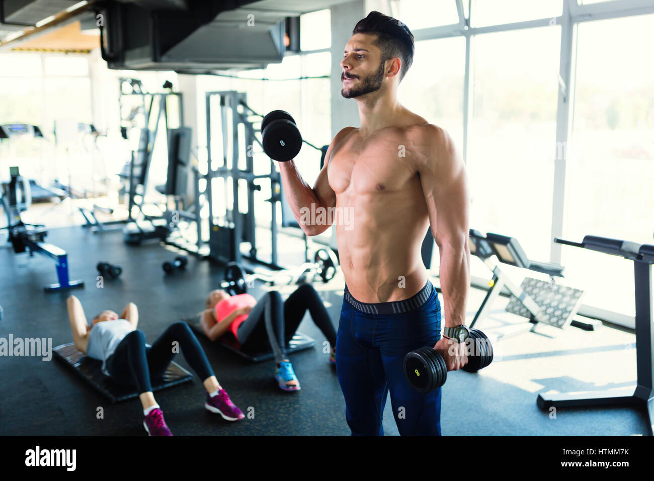 Determined people training and working out in gym Stock Photo - Alamy
