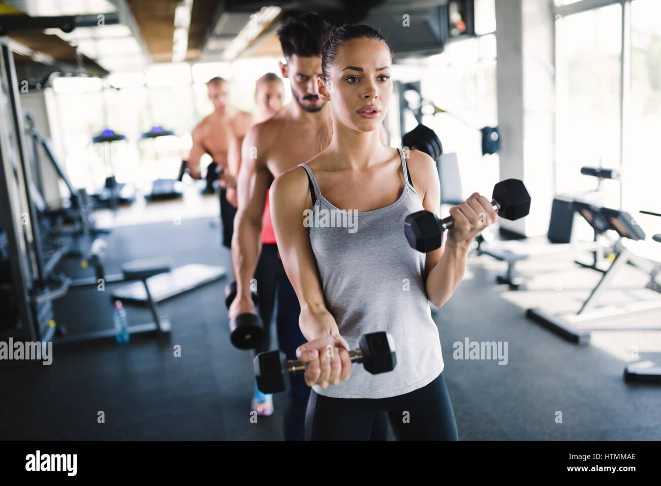 People working out at fitness training together in gym Stock Photo - Alamy