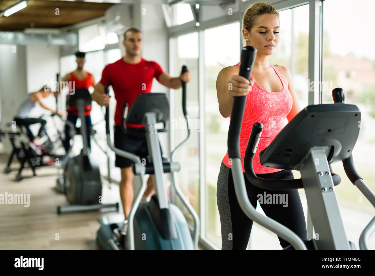 Determined people training and working out in gym Stock Photo - Alamy