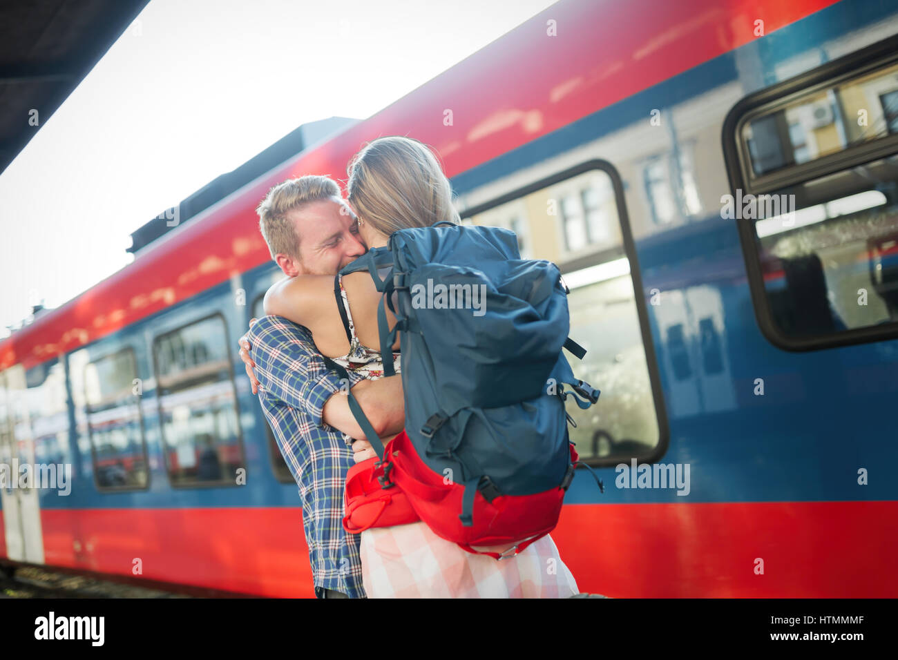 Couple in love reunion after traveler arrives Stock Photo - Alamy
