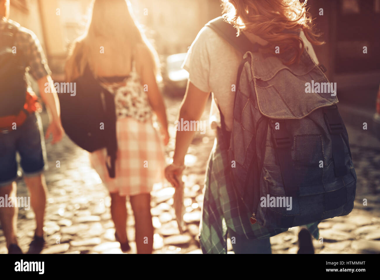 Group of backpackers and young people travelling and exploring city ...