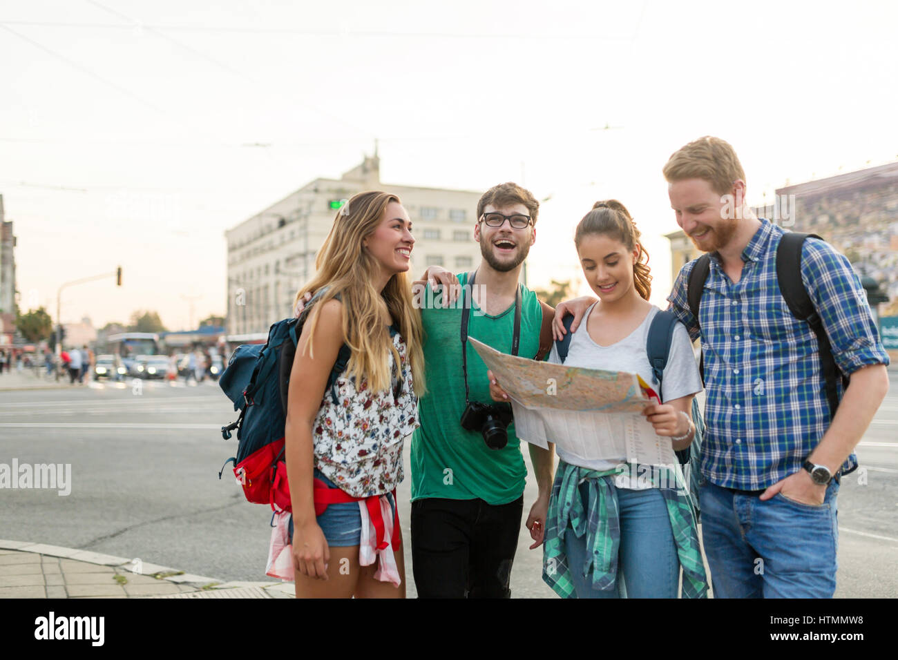 Happy tourists traveling and sightseeing in city Stock Photo - Alamy
