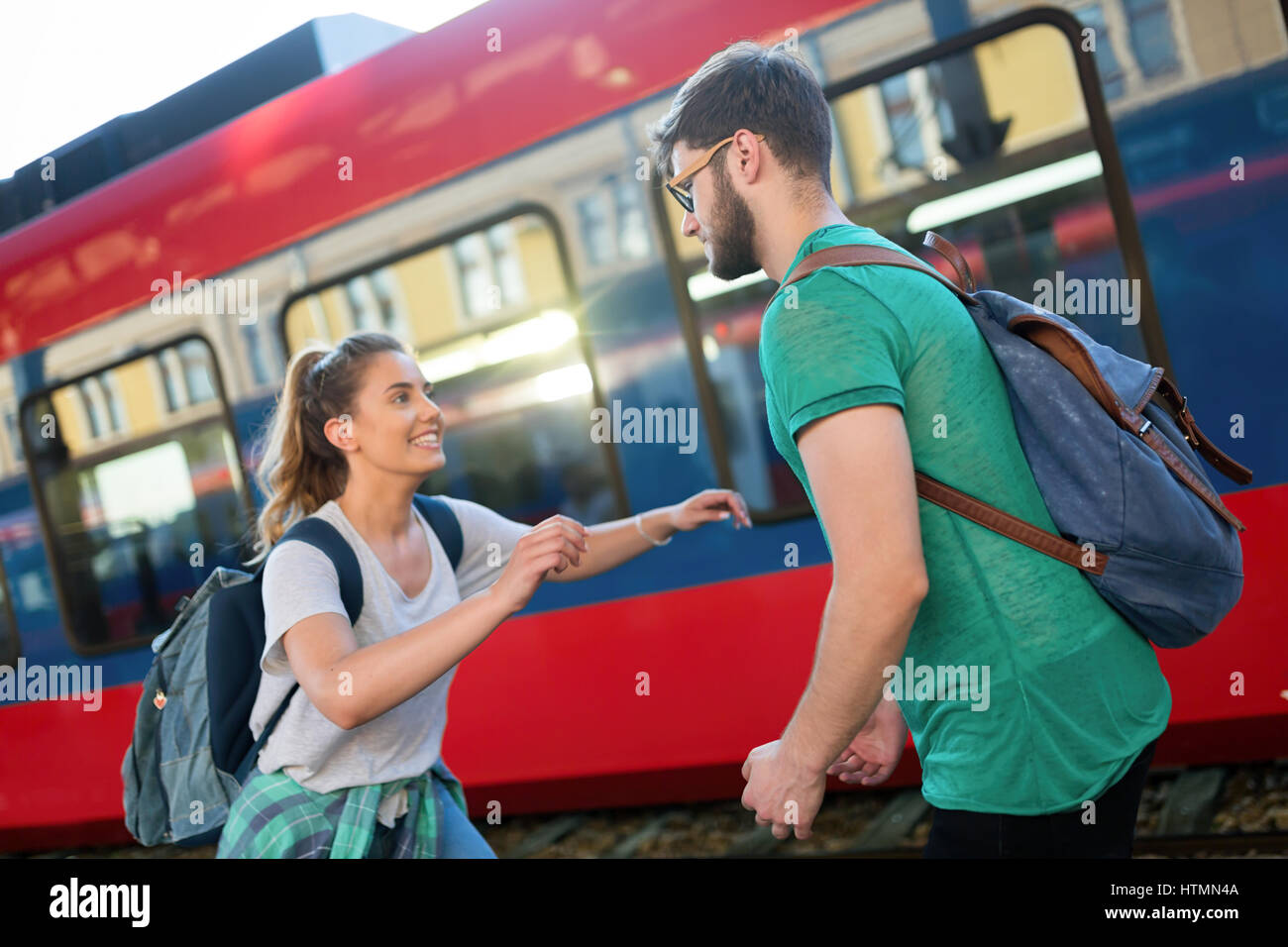 Couple in love reunion after traveler arrives Stock Photo - Alamy