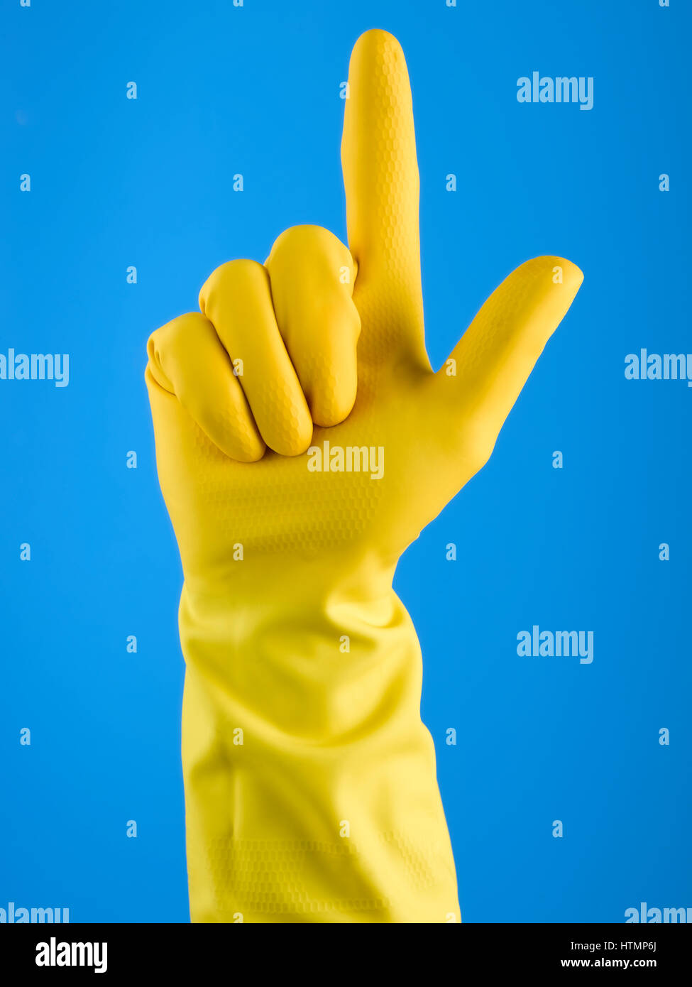 Yellow rubber glove pointing Stock Photo - Alamy