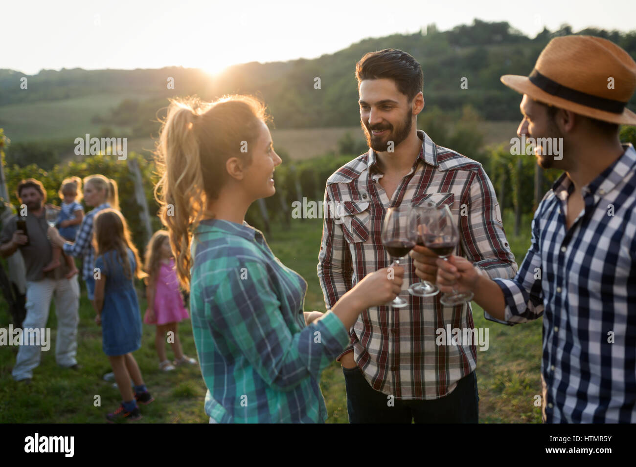 Happy people tasting wine in vineyard Stock Photo - Alamy