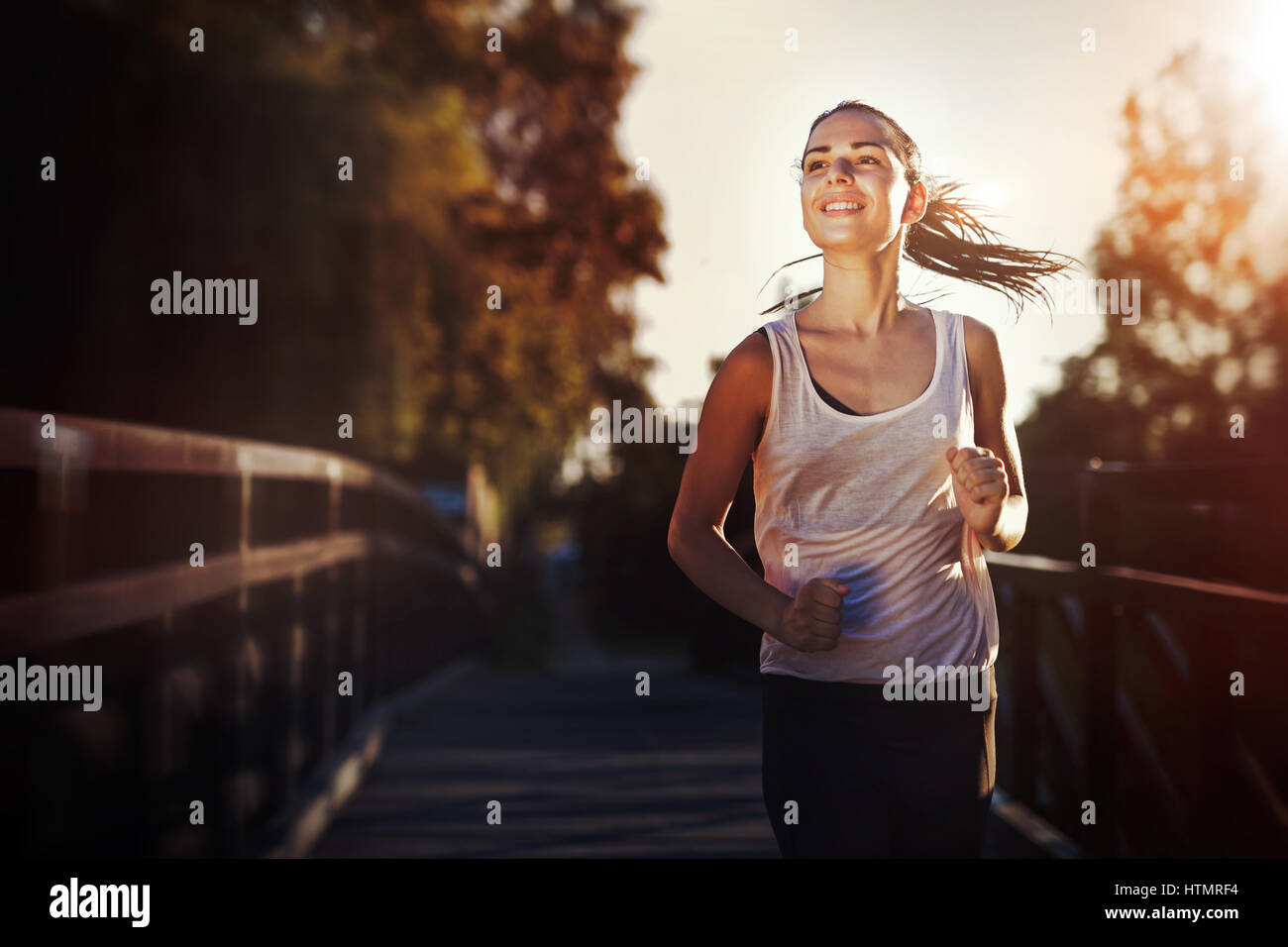 Sporty female jogger running and training outside in nature Stock Photo ...