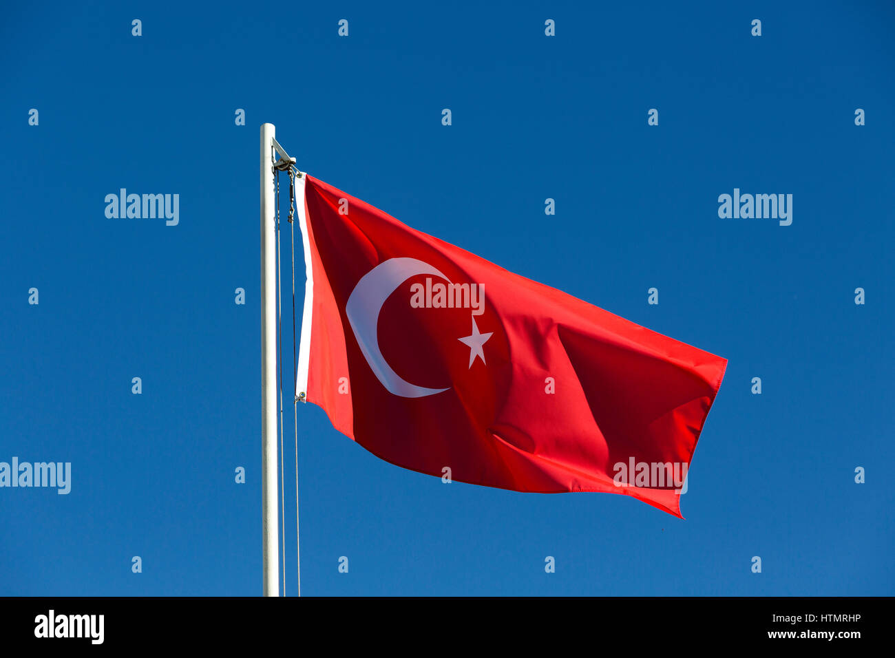 National flag of Turkey on a flagpole in front of blue sky Stock Photo ...