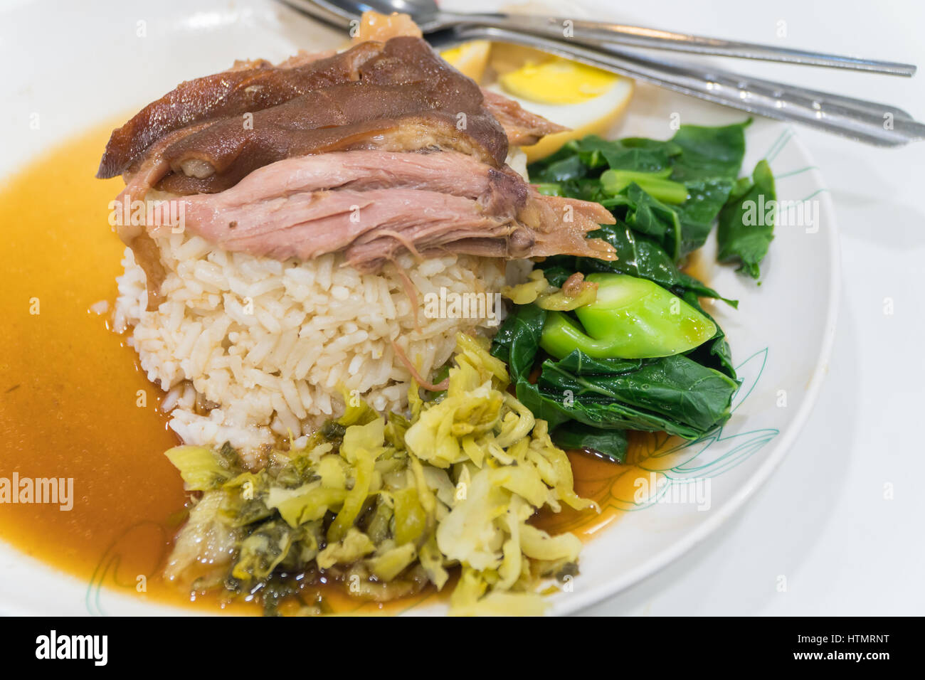 Stewed pork leg on rice with sauce.Thai food Stock Photo - Alamy