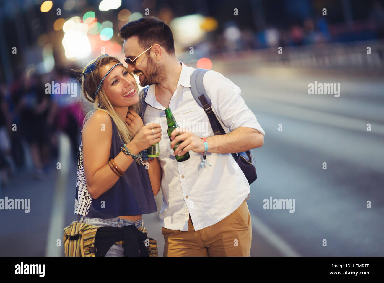 Couple drinking alcohol at night in city before festival Stock Photo ...