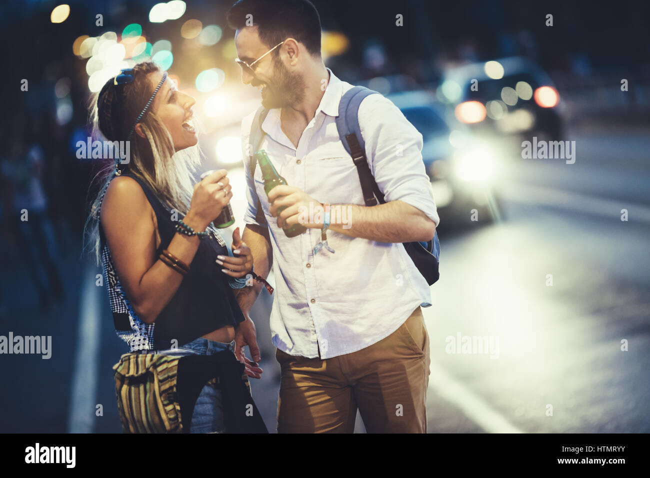 Couple drinking alcohol at night in city before festival Stock Photo ...