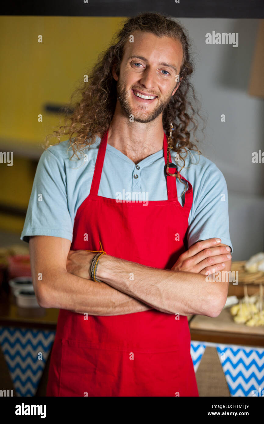 Portrait of staff standing at counter in market Stock Photo - Alamy