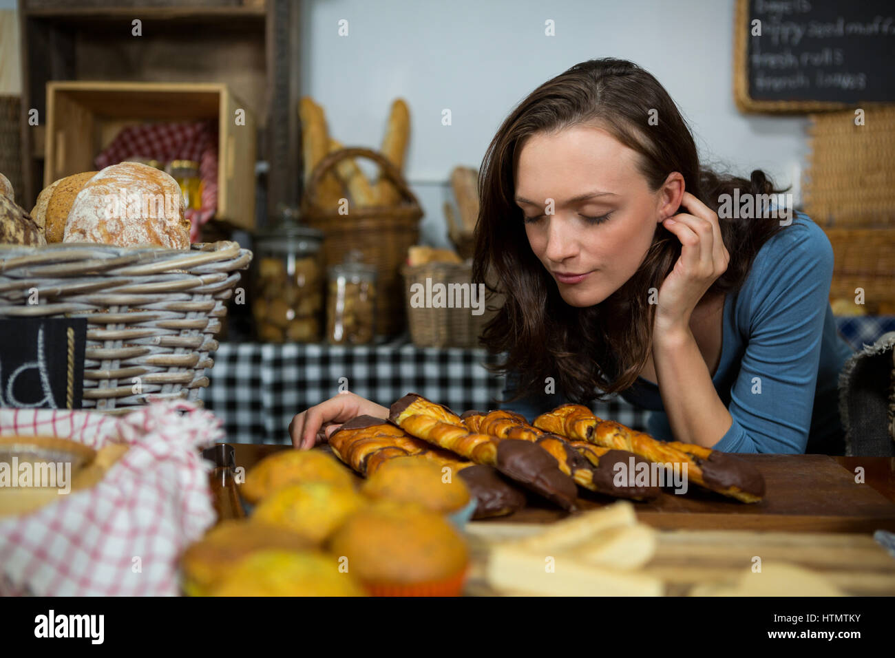 Woman smelling bread at bakery counter in market Stock Photo - Alamy
