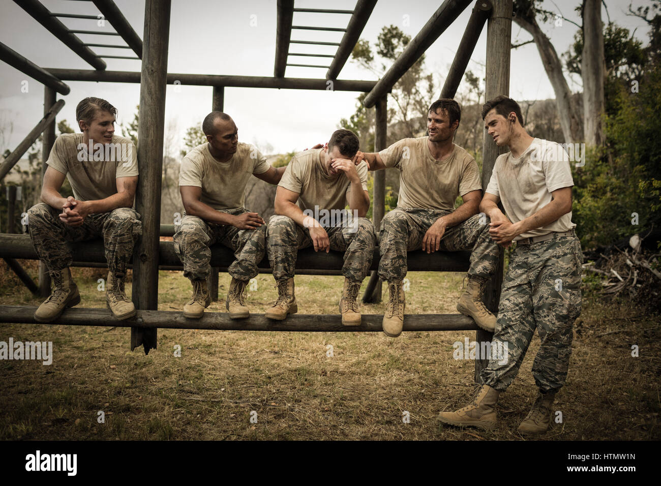 Soldiers comforting man in boot camp Stock Photo - Alamy