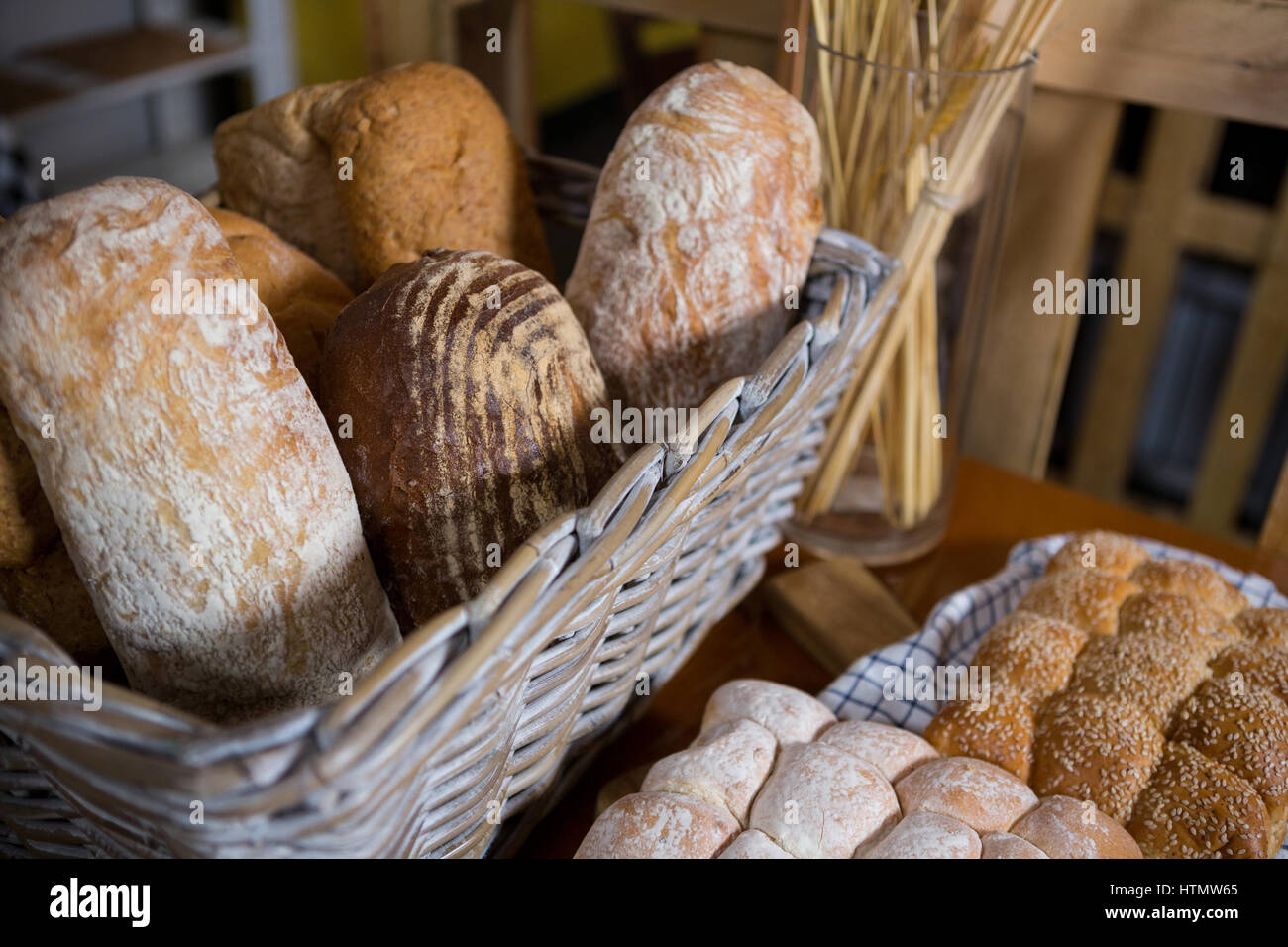 Close-up of fresh bread in a wicker basket on counter in bakery shop ...