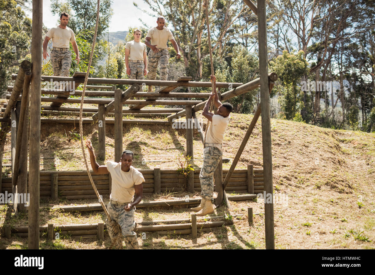 Military soldiers training rope climbing at boot camp Stock Photo - Alamy