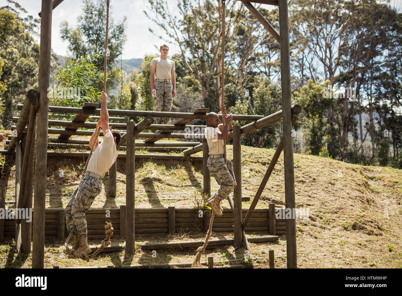 Military soldiers training rope climbing at boot camp Stock Photo - Alamy